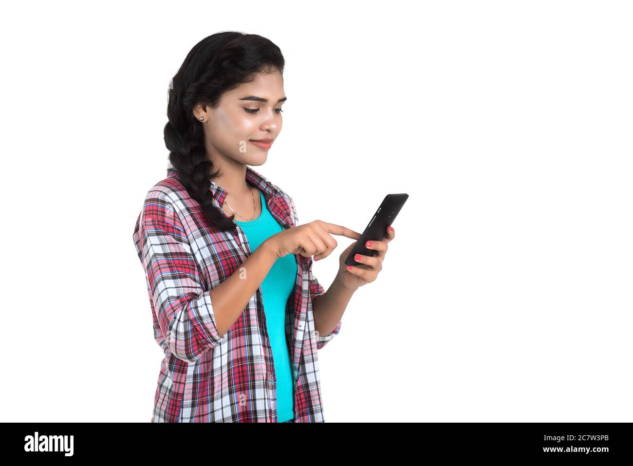 Young Indian girl using a mobile phone or smartphone isolated on a ...