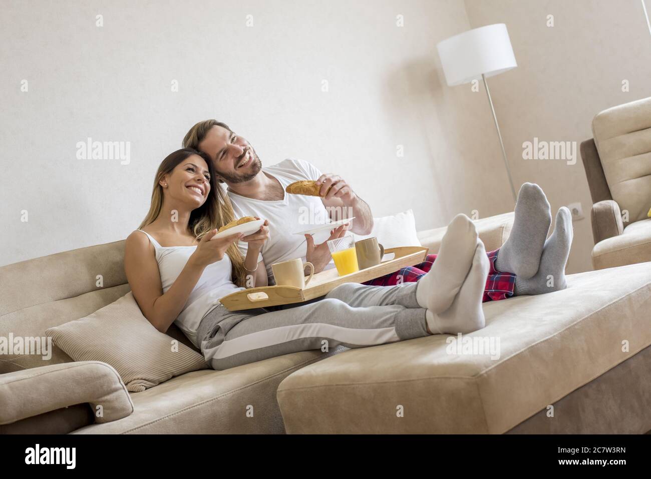 Family eating breakfast on sofa hi-res stock photography and images - Alamy