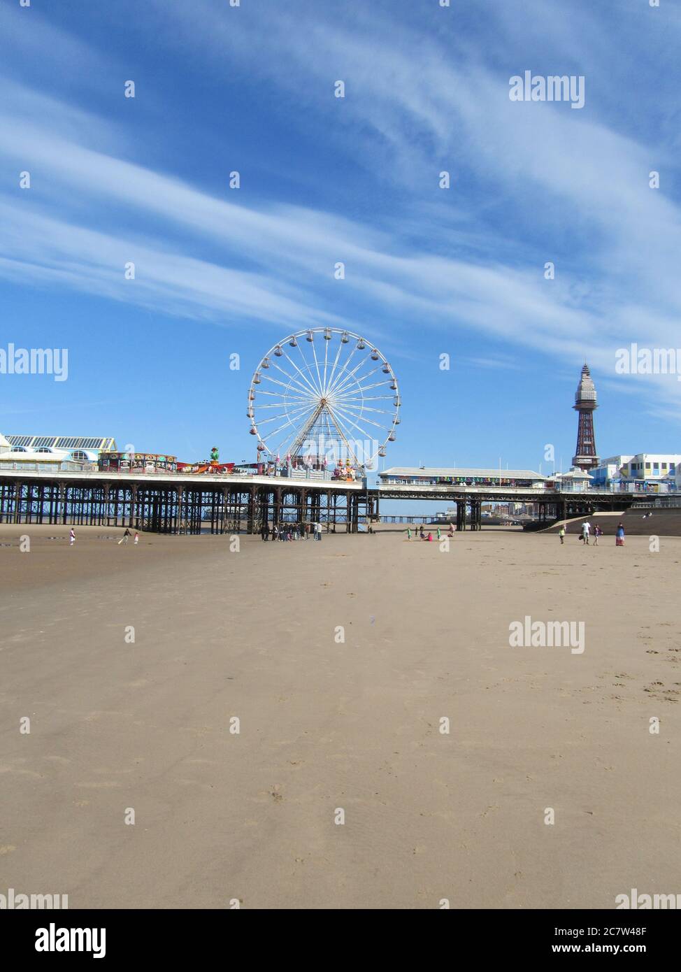 a view of a Ferris wheel as light begins to fade and the lights on the ...