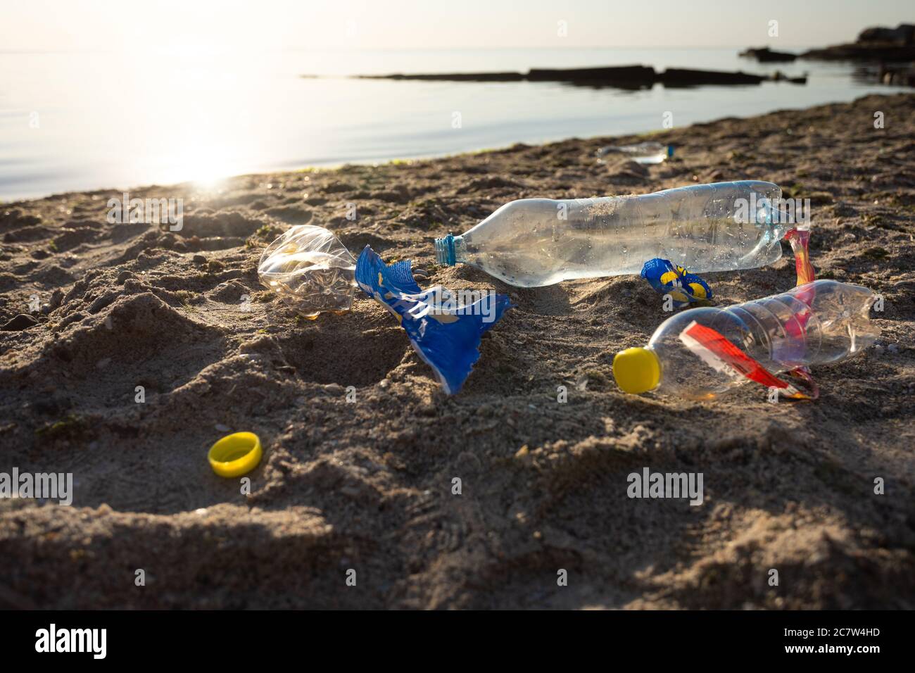 Plastic Litter Lying On Sand Near Sea Polluting Seashore Background ...