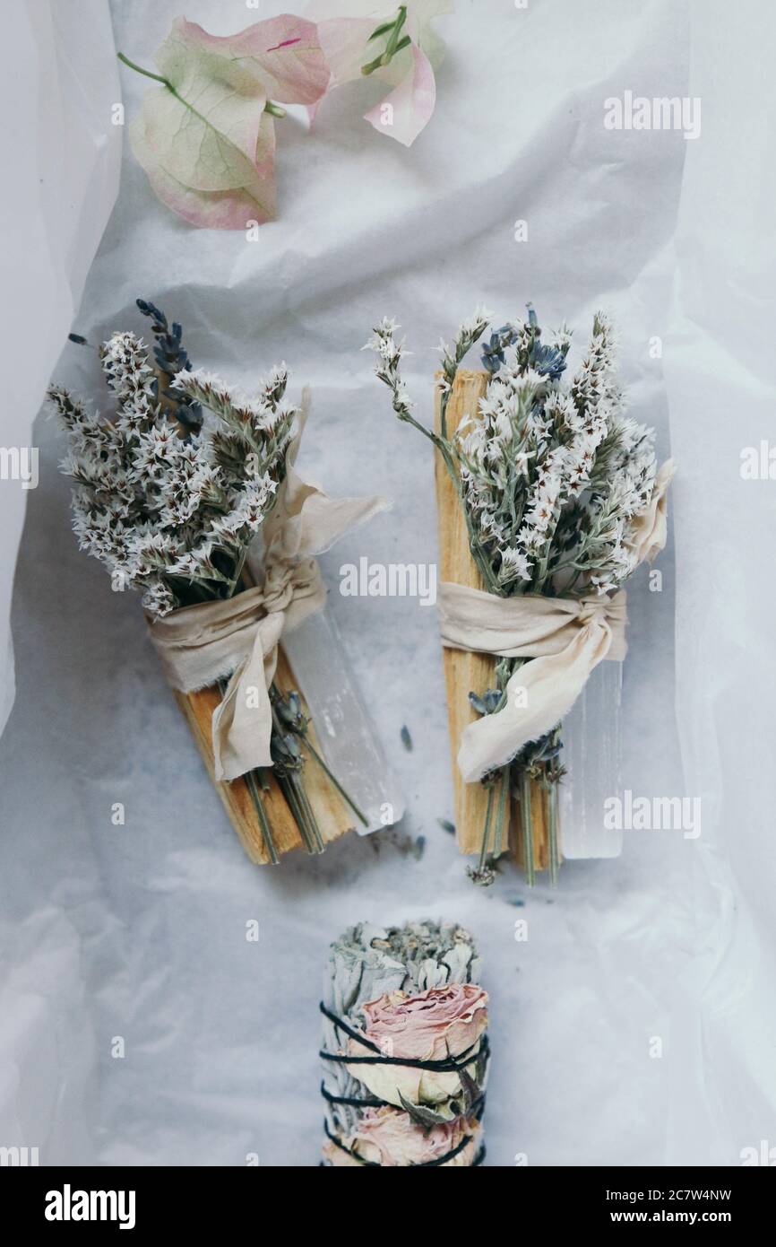 Overhead shot of beautifully arrange smudge sticks on white wrapping ...