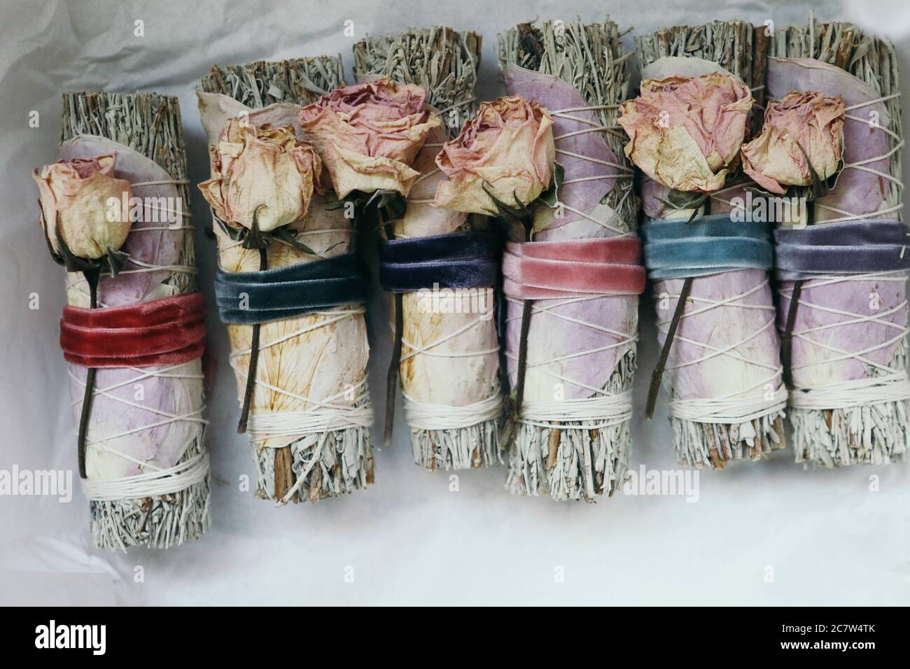 Overhead shot of beautifully arrange smudge sticks on white wrapping ...
