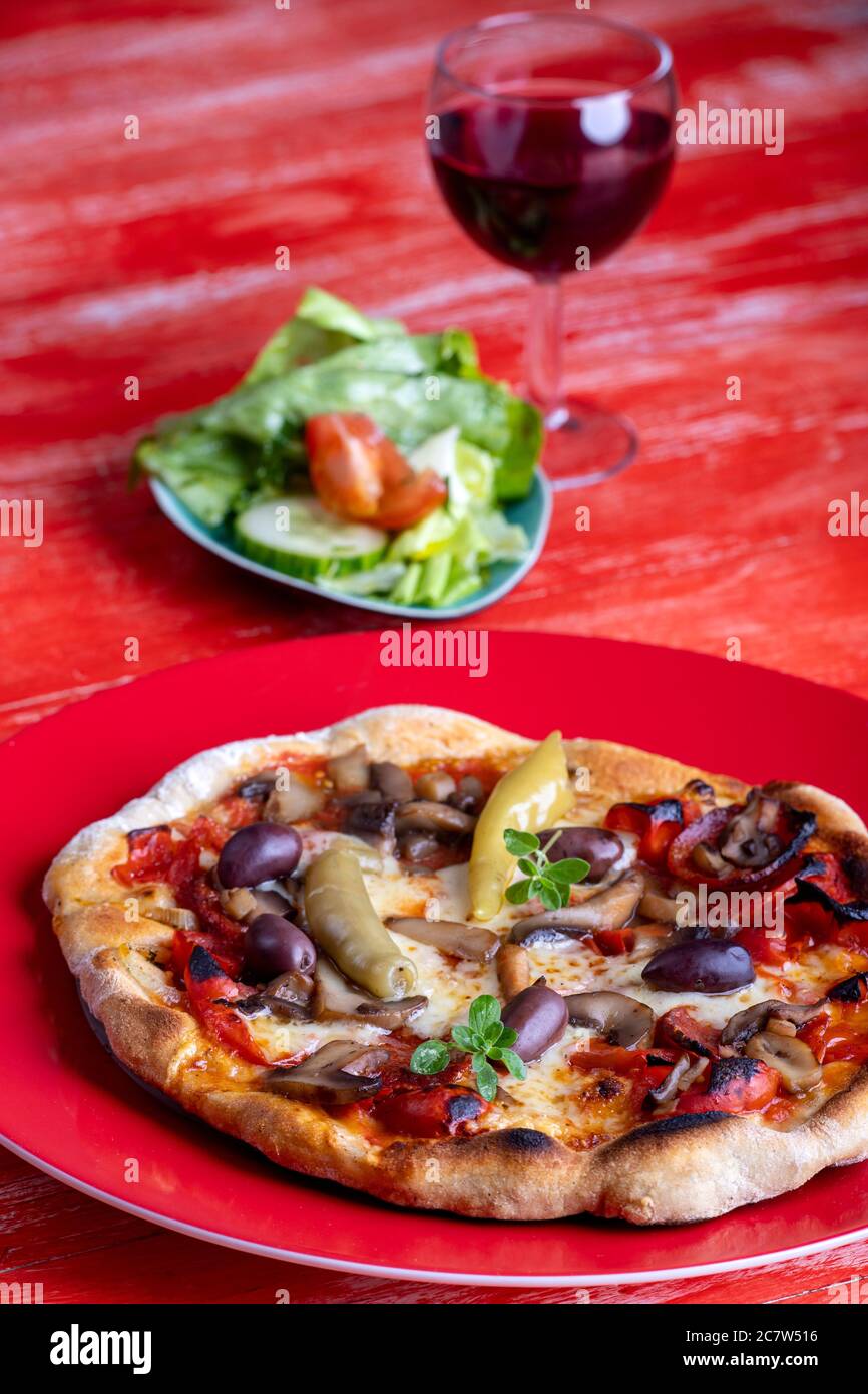 fresh pizza on a red background Stock Photo - Alamy