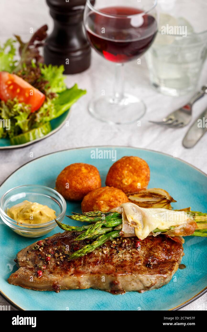 green asparagus on a steak Stock Photo - Alamy