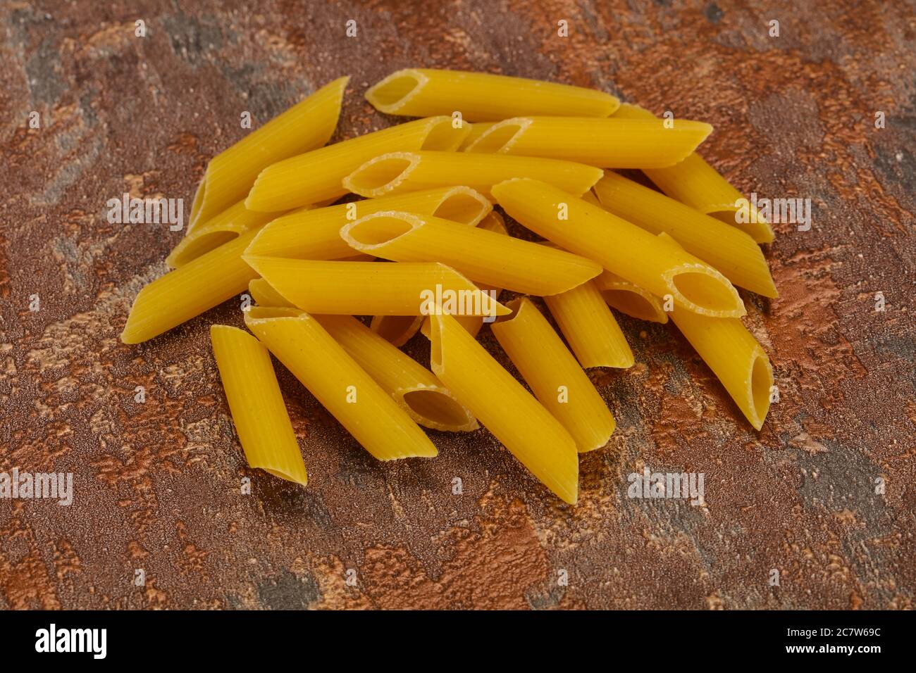 Raw penne pasta ready for bowl Stock Photo - Alamy