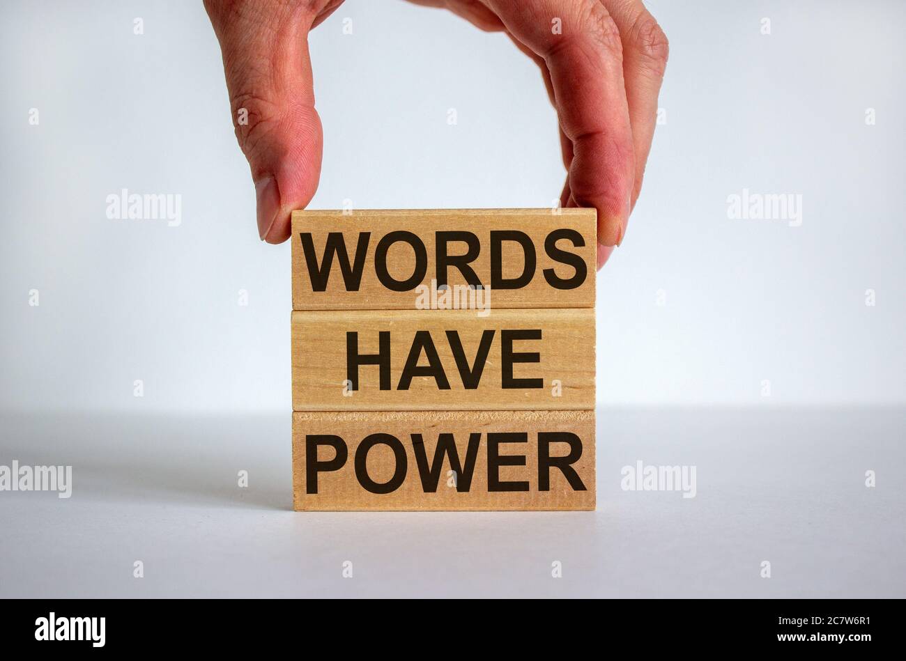 Male hand placing a block with word 'words' on top of a blocks tower ...