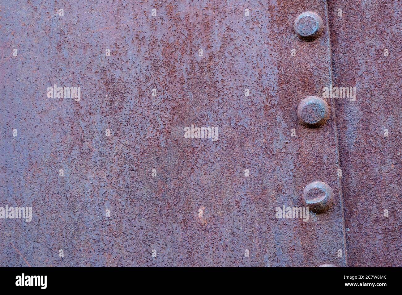 Fragment Rusty riveted hull of an old ship. Large metal rivets metal ...