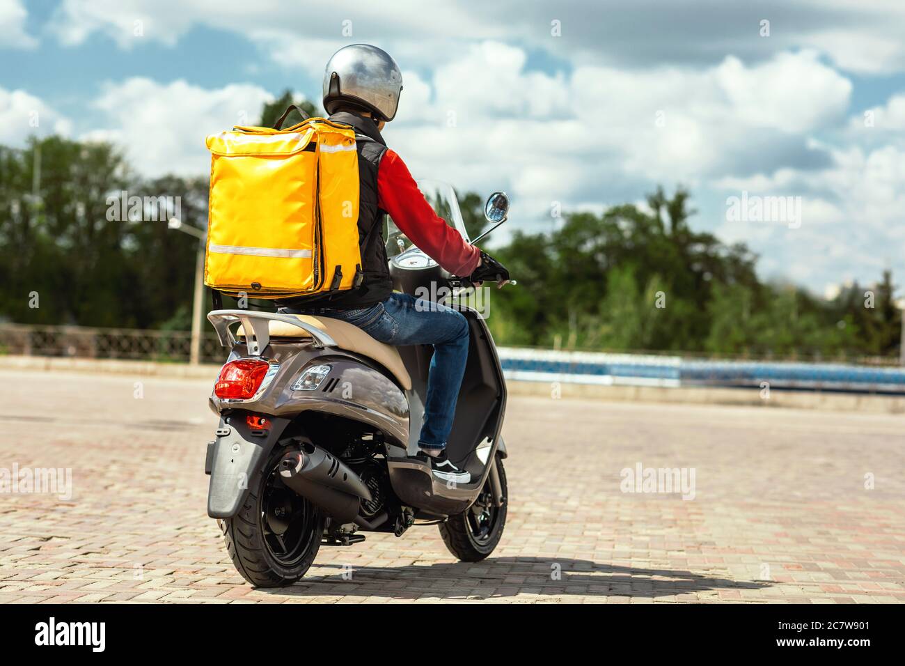 Back view riding scooter in hi-res stock photography and images - Alamy