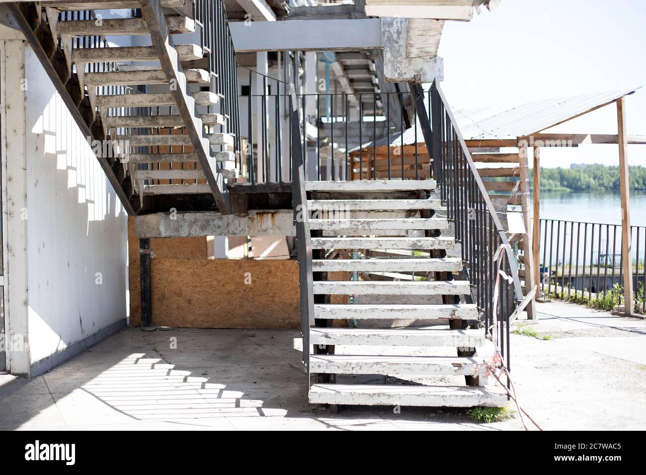 Old metal and concrete stairs with a handrail outside the building near ...