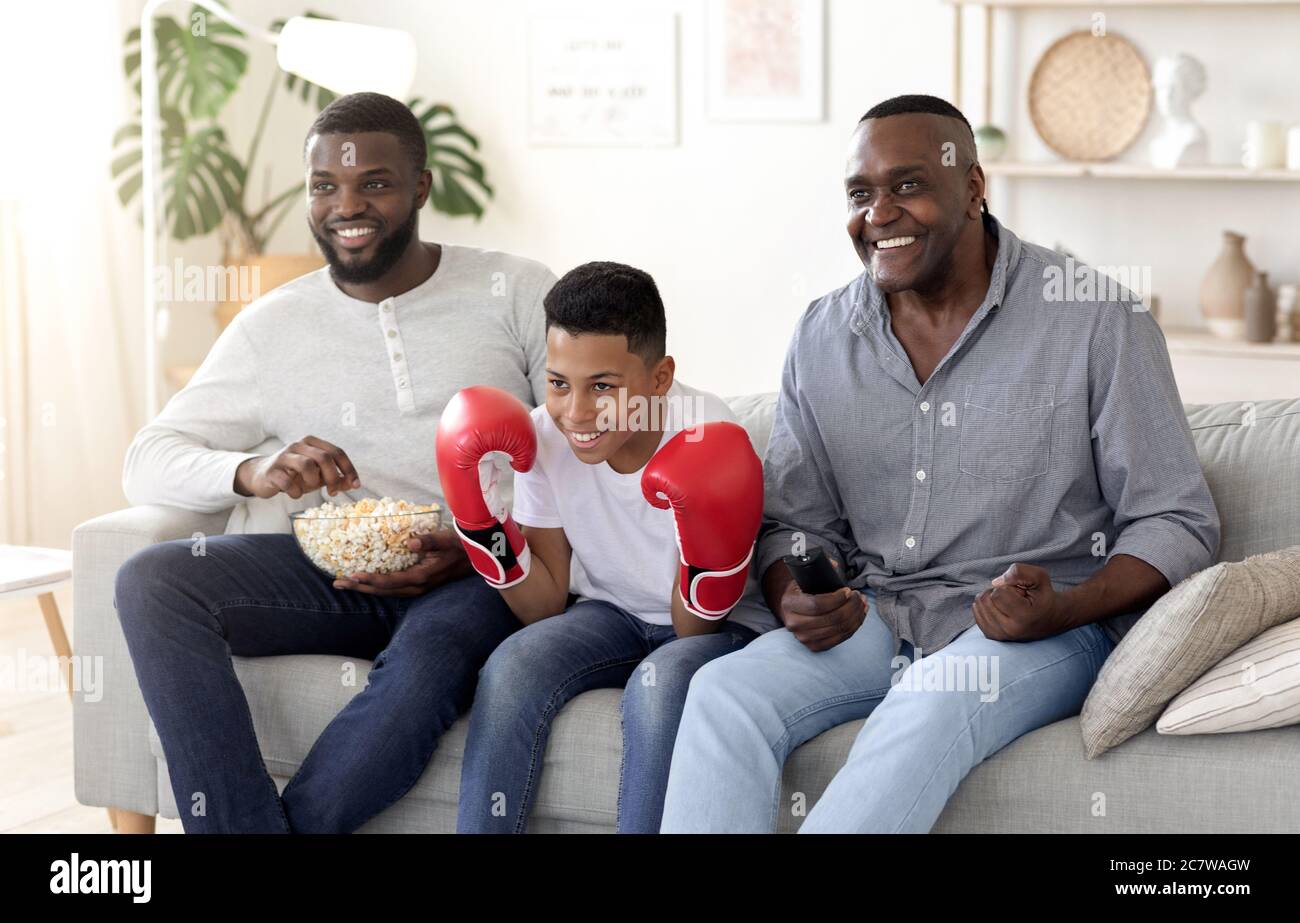 Black Dad, Son And Grandfather Watching Boxing Match On Tv And Cheering ...