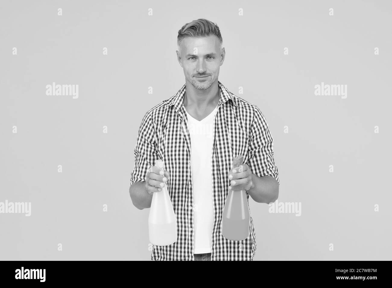 Cleaning made simple. Cleaning man yellow background. Handsome guy hold ...