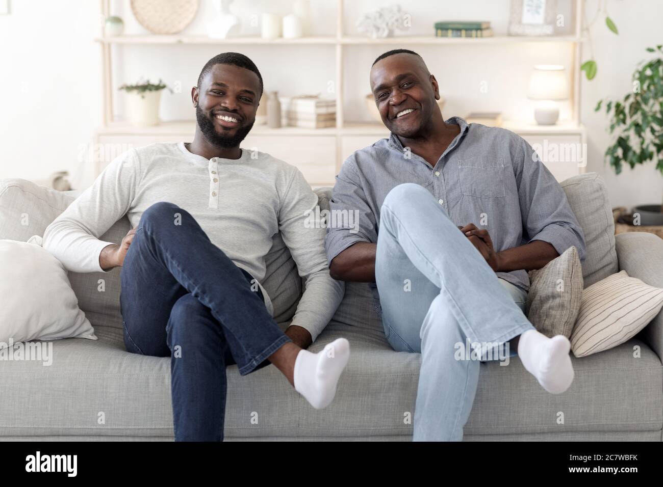 Like Father Like Son. Happy Man Sitting In Similar Pose With Dad Stock ...