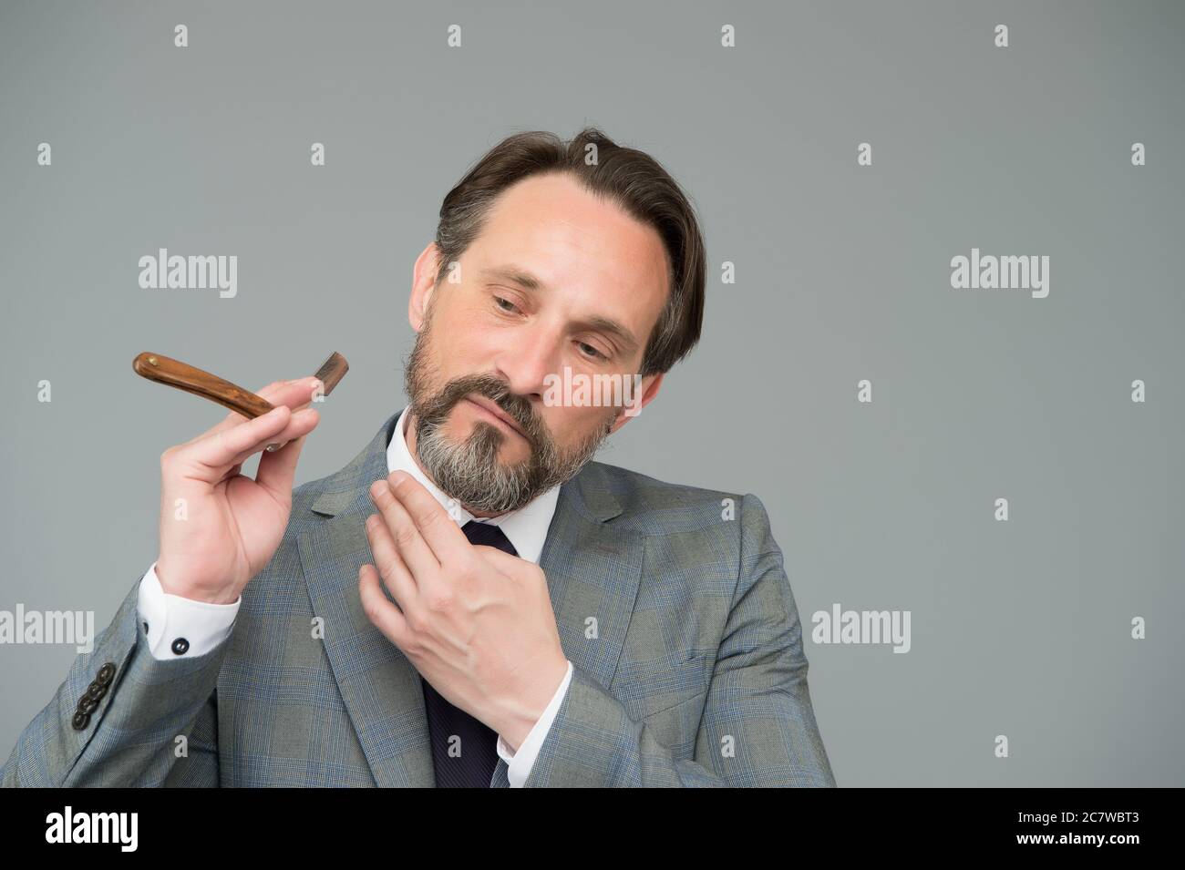 Man shaving straight razor grooming beard, skillful barber concept ...