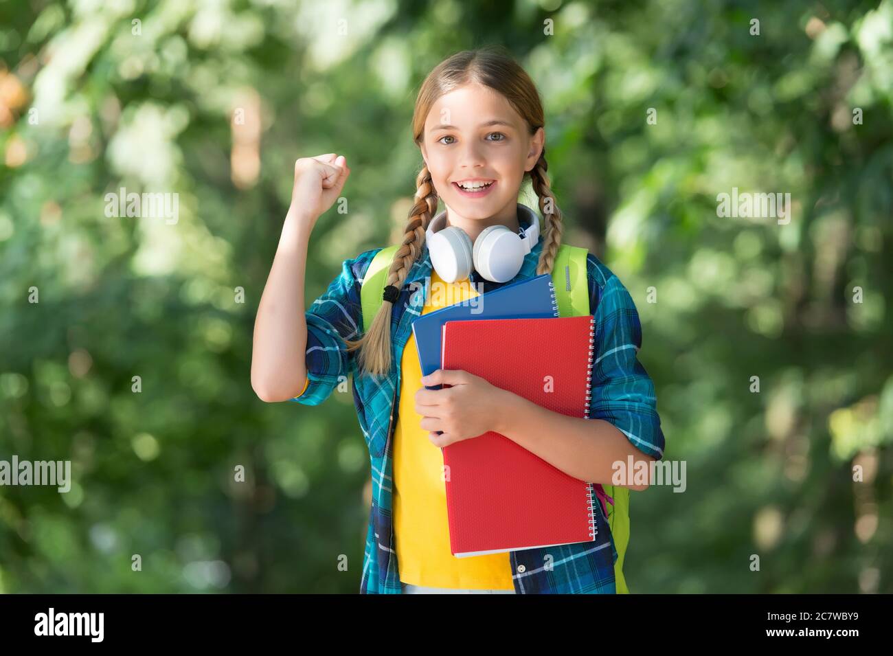 Homework done. Happy kid celebrate back to school. Little child hold ...