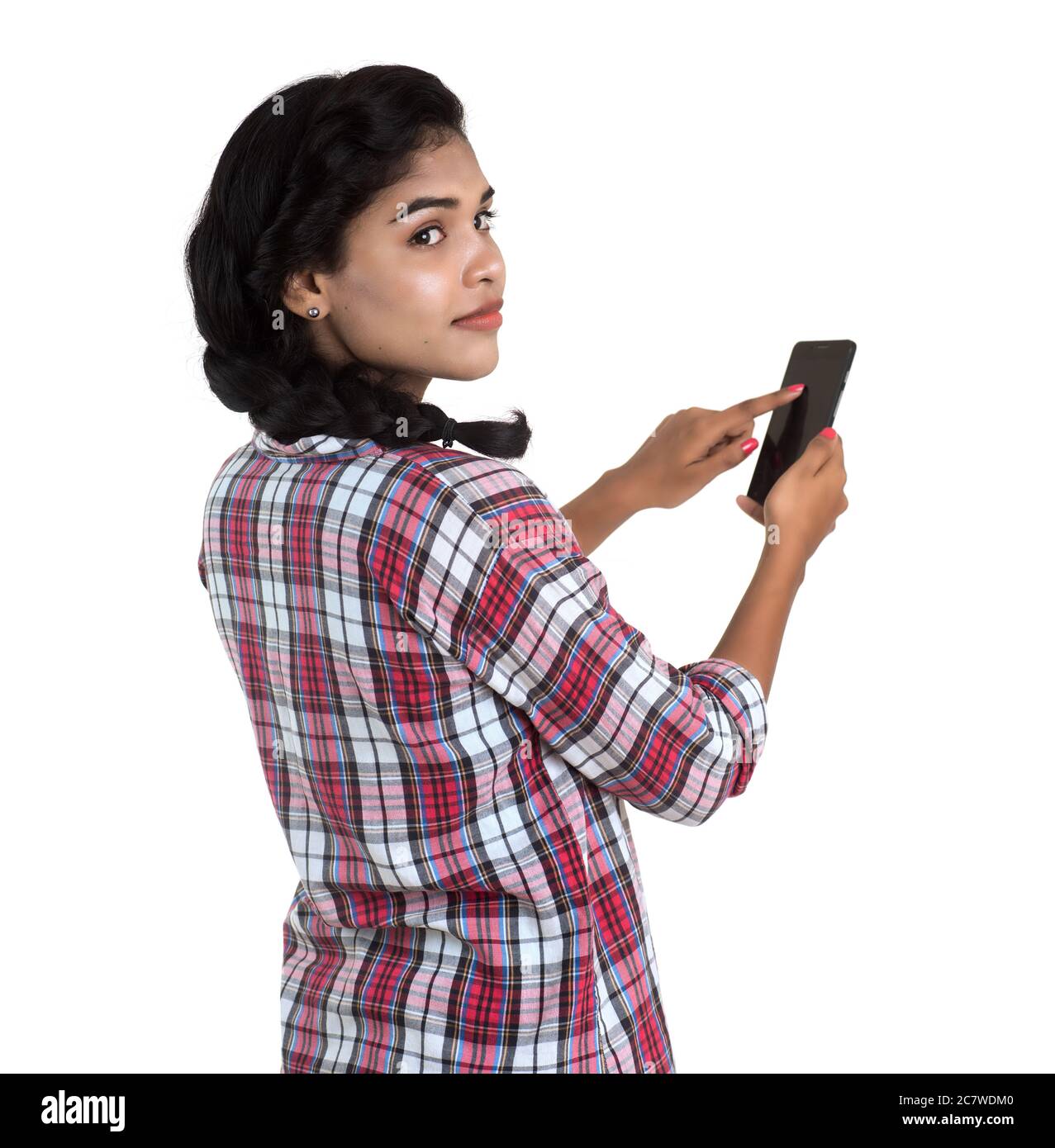 Young Indian girl using a mobile phone or smartphone isolated on a ...