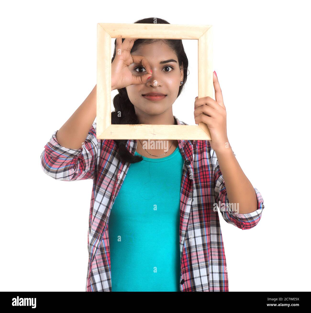 attractive young woman holding and posing with Picture frame on a white ...