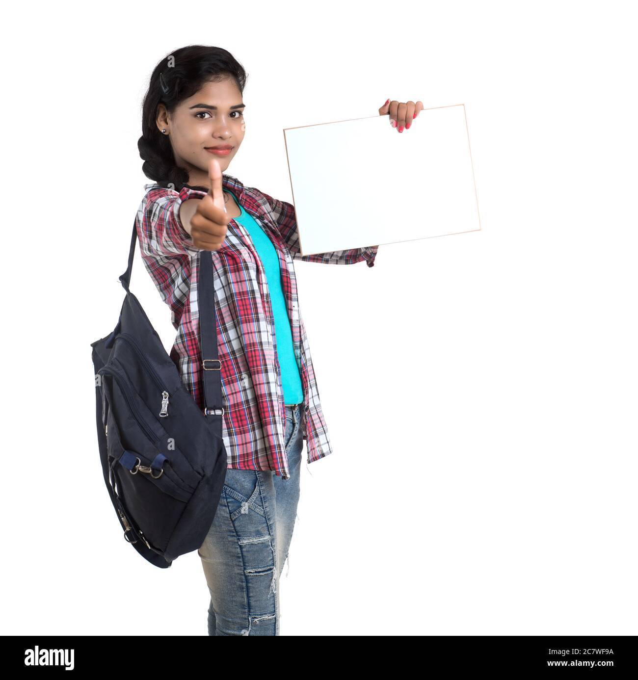 young Indian woman with backpack standing and holding white board ...