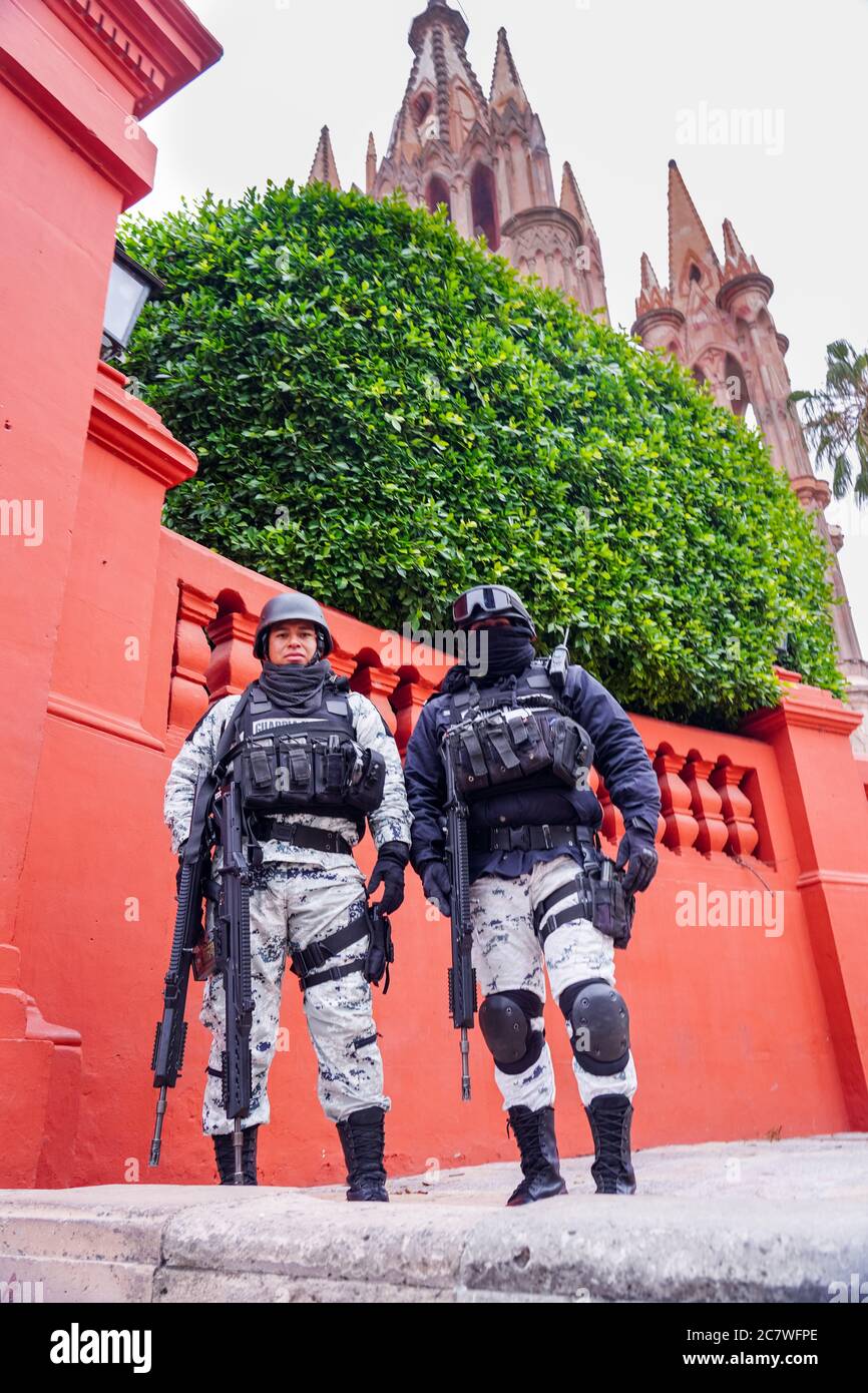 Heavily armed Mexican National Guard soldiers stand guard by the ...