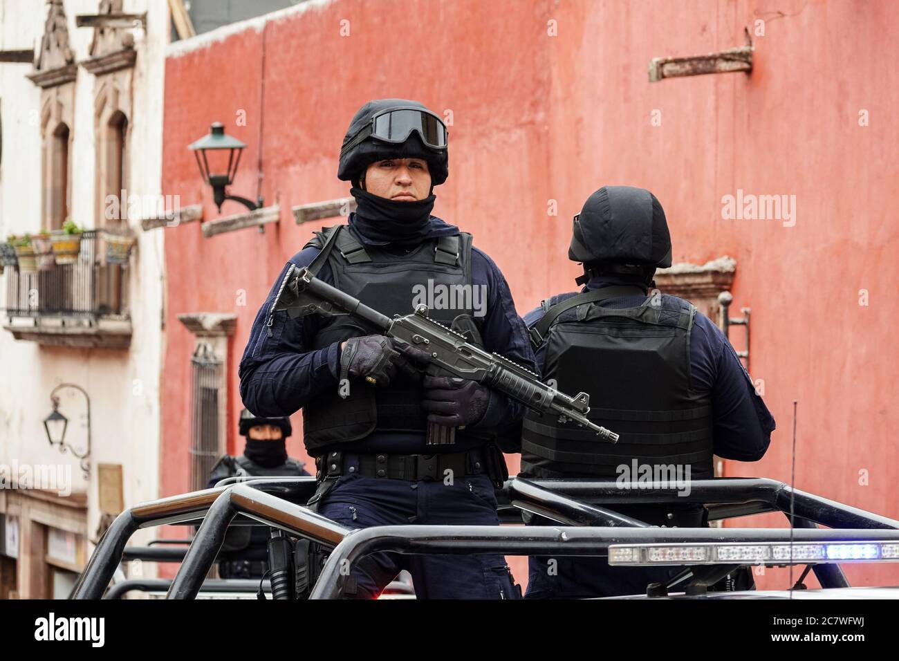 Heavily armed Mexican policemen patrol the historic center during ...