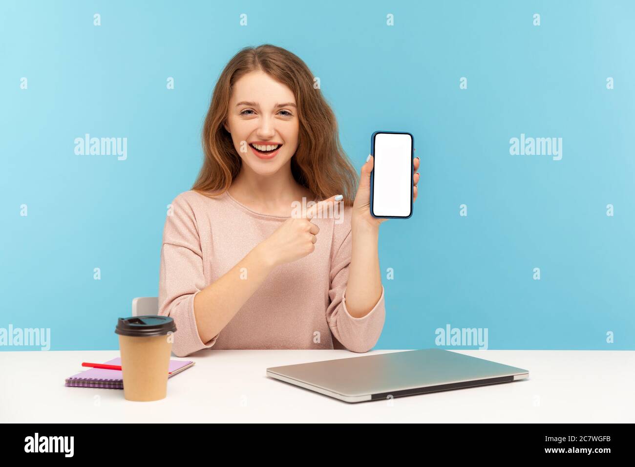 Joyful smiling woman, office employee, sitting at workplace and ...
