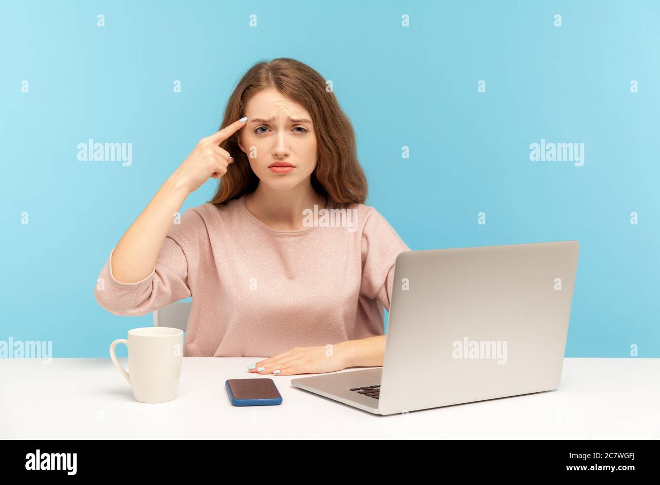 This is crazy silly idea! Displeased woman sitting at workplace with ...