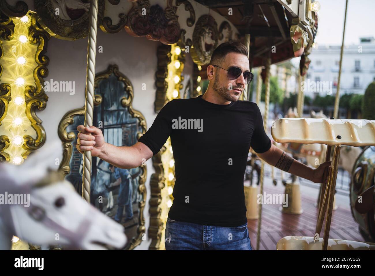 Young Caucasian male spending fun time in an attraction park with a ...