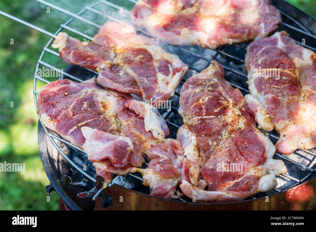 Grilling pork meat on garden barbecue grill Stock Photo - Alamy