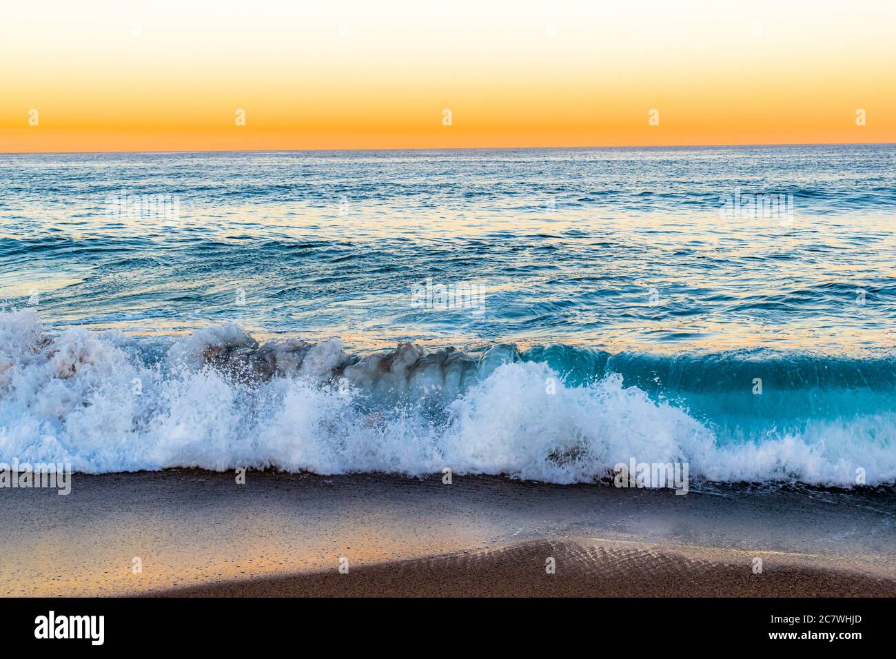 Beautiful shot of waves on the beach during sunset Stock Photo - Alamy