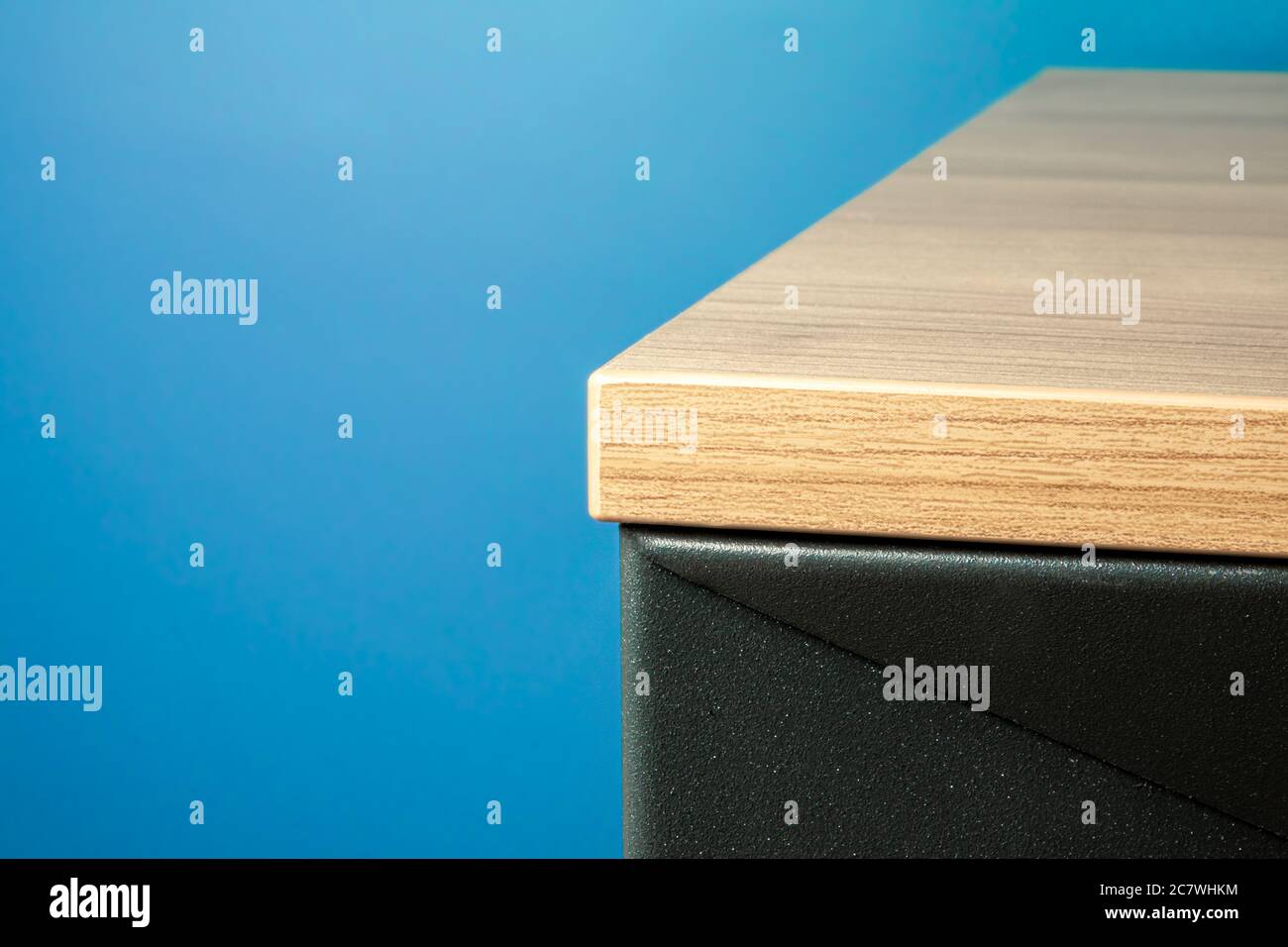 Close-up of a table corner solid wood furniture detail with blue ...
