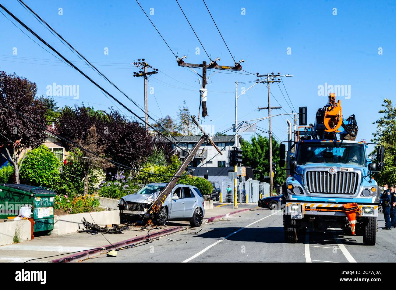 A Mercedes SUV crashes into a utility pole and shears it off and ...
