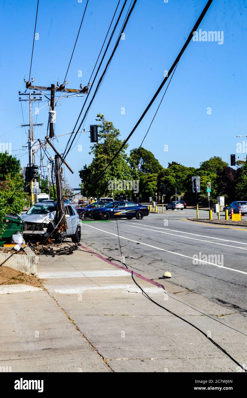 A Mercedes SUV crashes into a utility pole and shears it off and ...