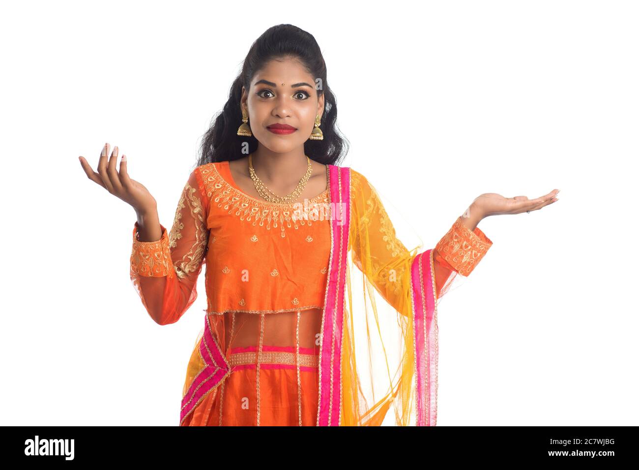 Portrait of cheerful Indian traditional young woman presenting ...