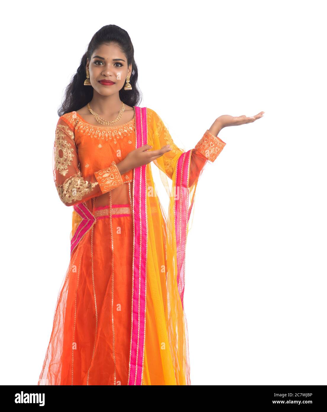 Portrait of cheerful Indian traditional young woman presenting ...