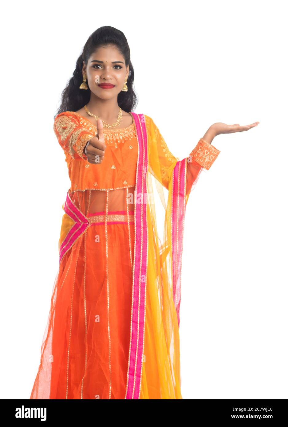 Portrait of cheerful Indian traditional young woman presenting ...