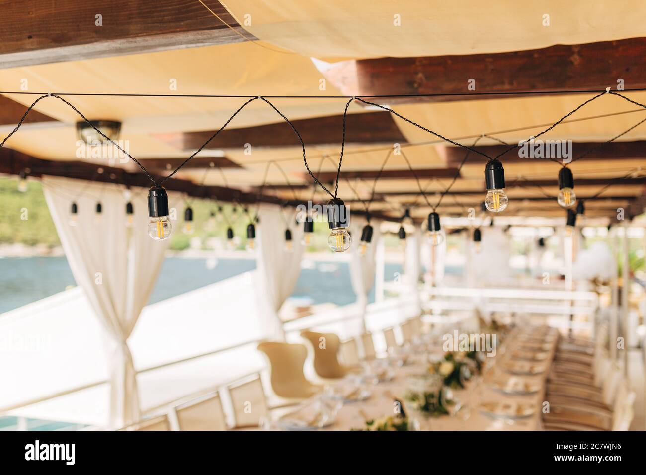 Garlands of LED lamps over a banquet table for a wedding dinner Stock ...