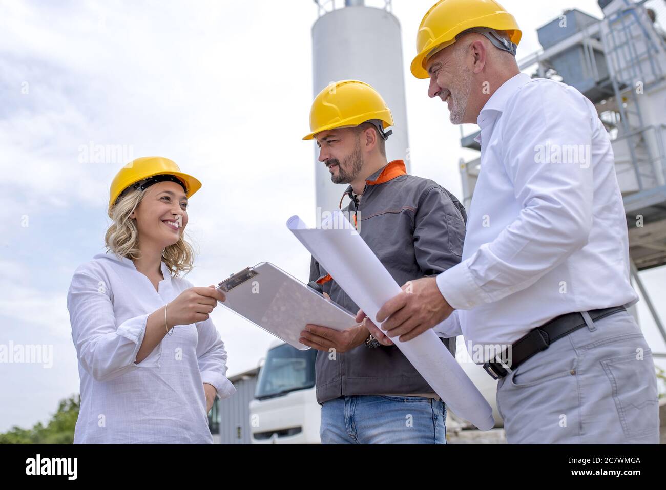 Group of engineers on site discussing the construction plan and ...