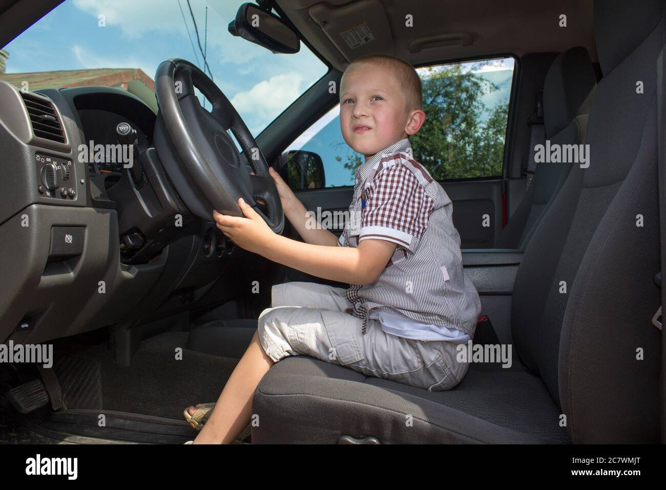 child driving a car with open doors Stock Photo - Alamy