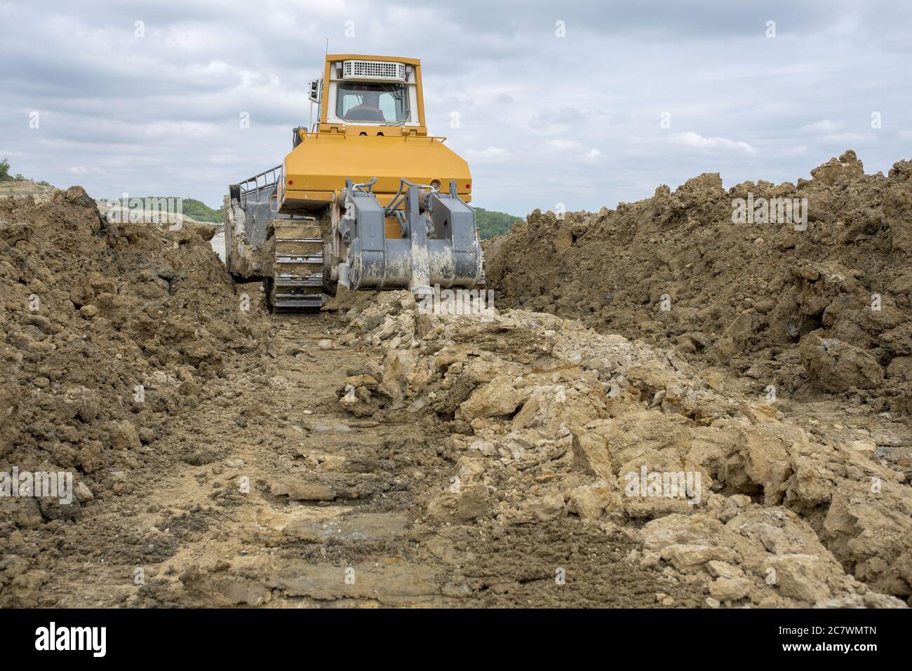 Bulldozer moving soil and rocks at a construction site Stock Photo - Alamy