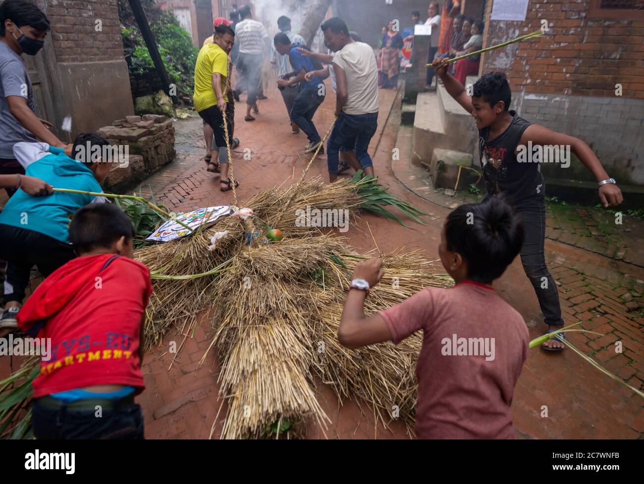 Children hitting the straw effigy of demon ghantakarna during the ...