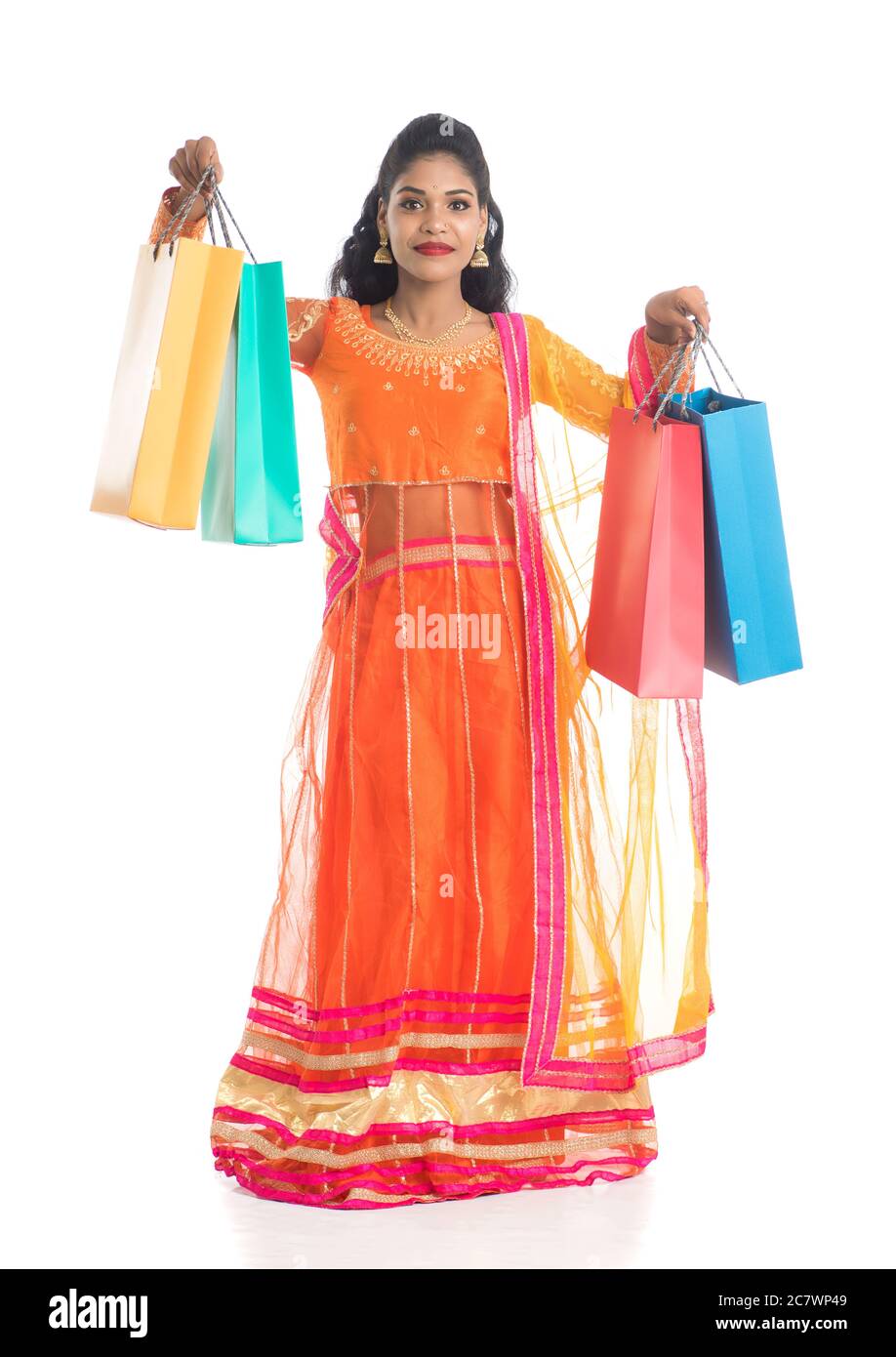 Beautiful Indian young girl holding shopping bags while wearing ...