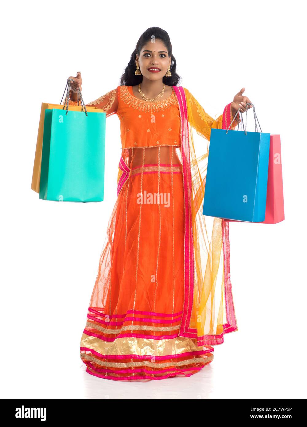 Beautiful Indian young girl holding shopping bags while wearing ...