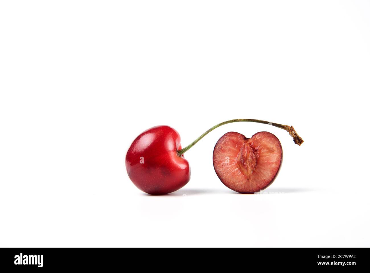A red juicy fresh cherry on white background Stock Photo - Alamy