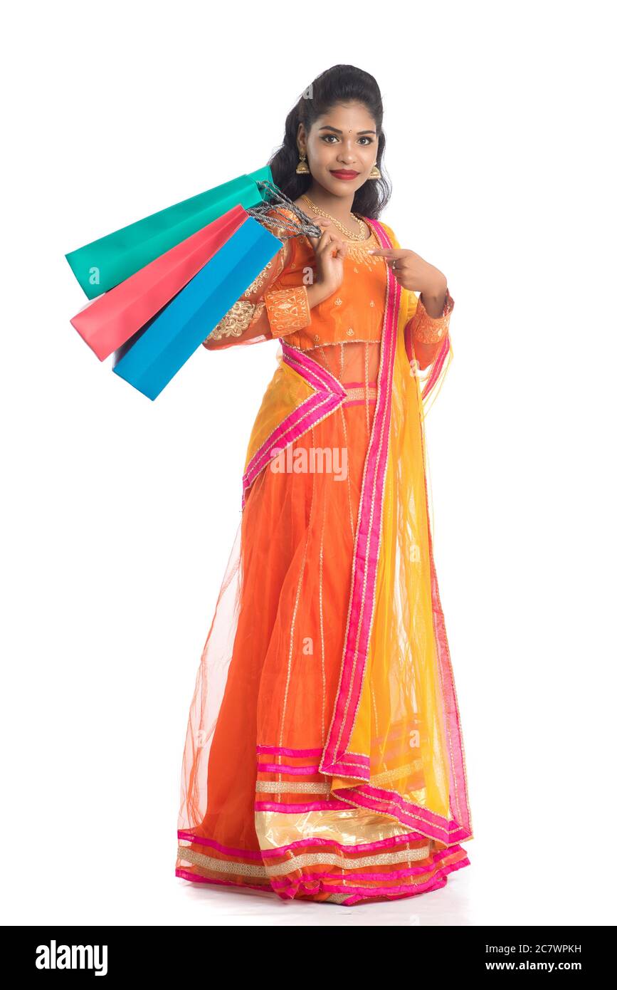 Beautiful Indian young girl holding shopping bags while wearing ...