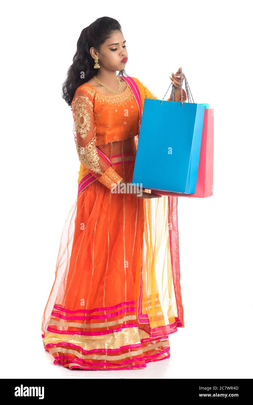 Beautiful Indian young girl holding shopping bags while wearing ...
