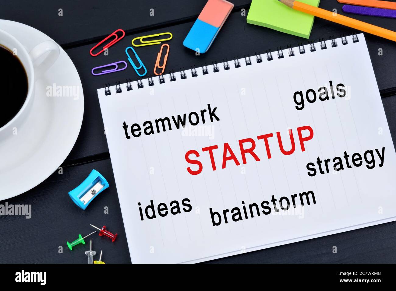 Startup word on notebook on a black wooden table Stock Photo - Alamy