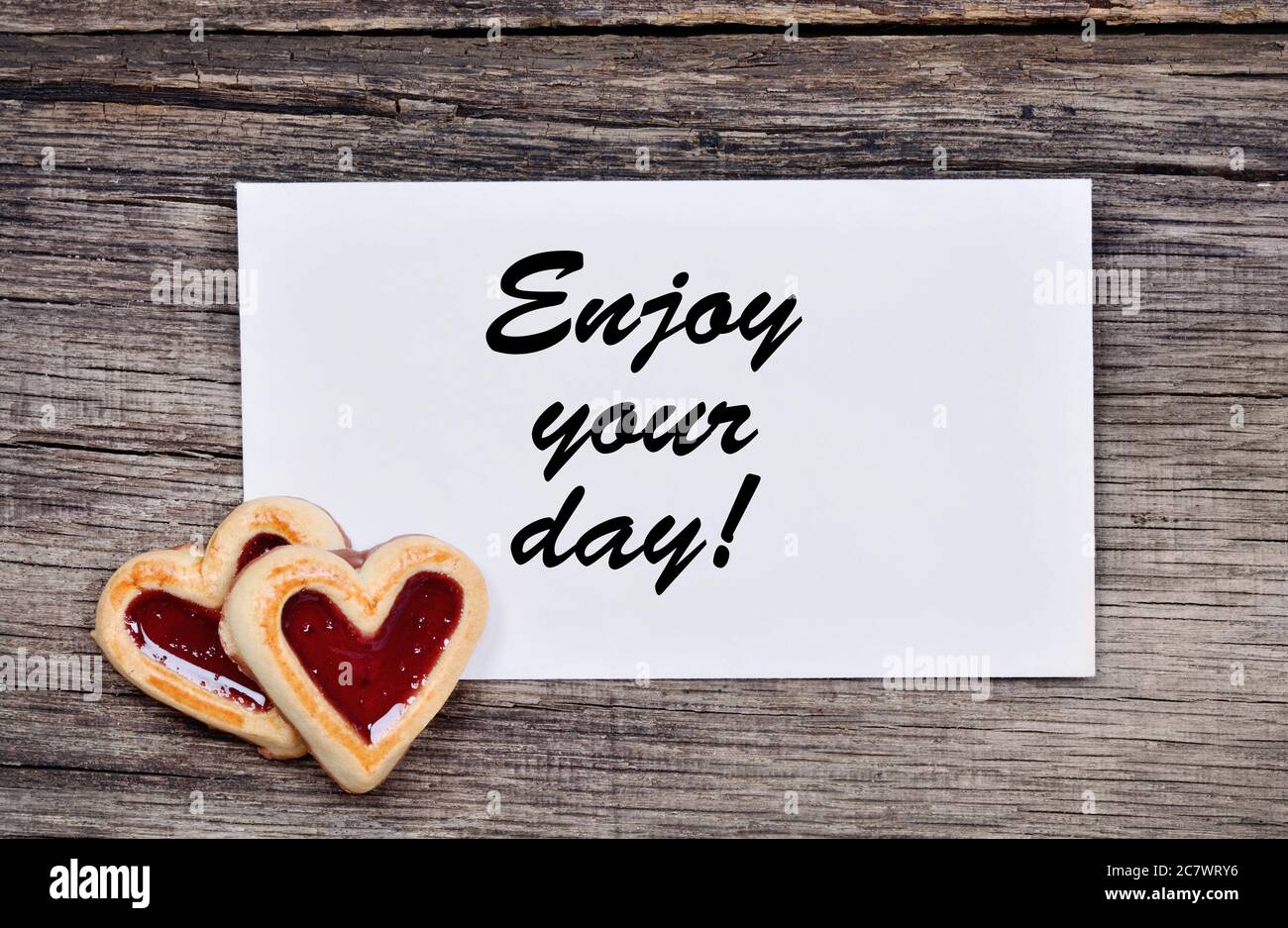 Enjoy your day! Text on paper on a wood background Stock Photo - Alamy