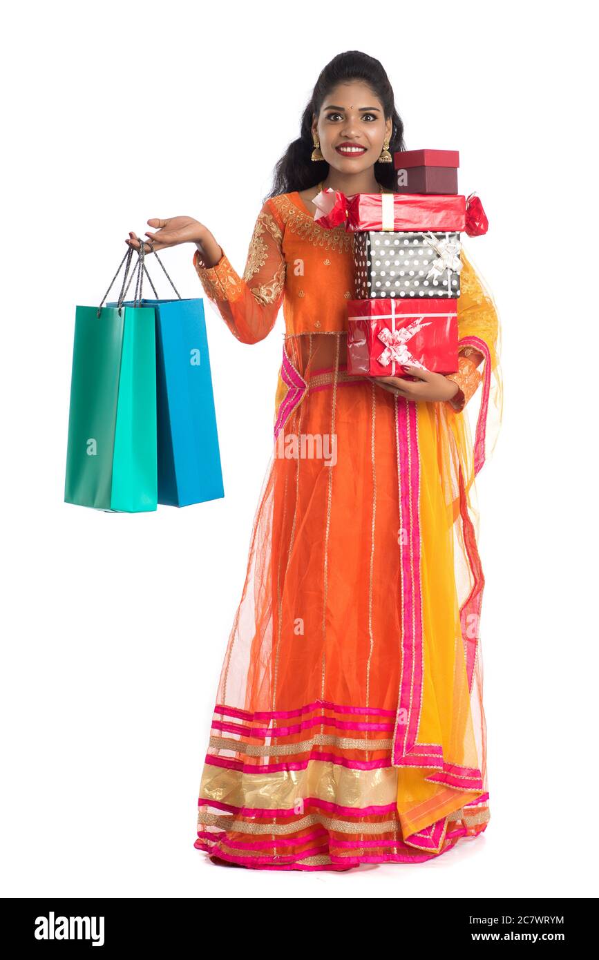 Beautiful woman carrying many shopping bags and gift Box on a white ...