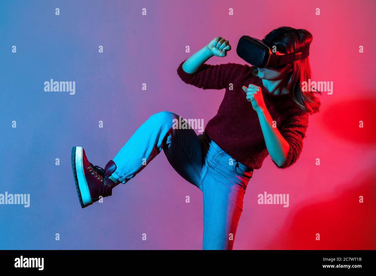 Leisure activity. Girl with virtual reality glasses playing game ...