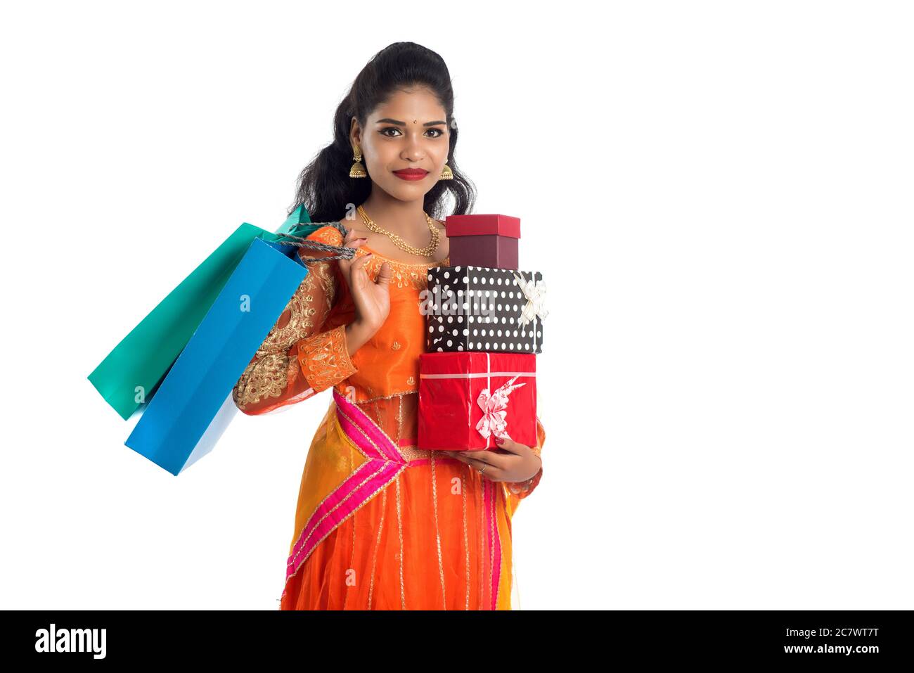 Beautiful woman carrying many shopping bags and gift Box on a white ...