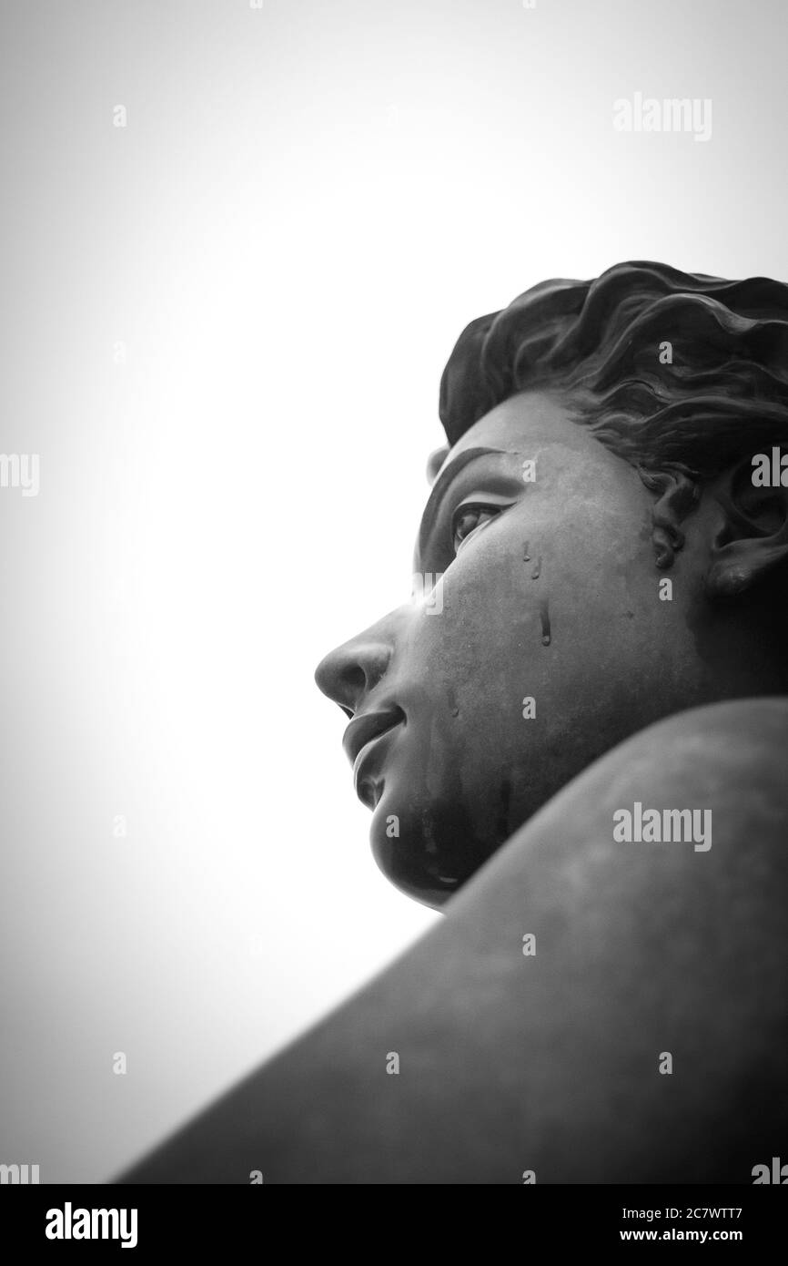 Low angle shot of a crying lady stone statue Stock Photo - Alamy